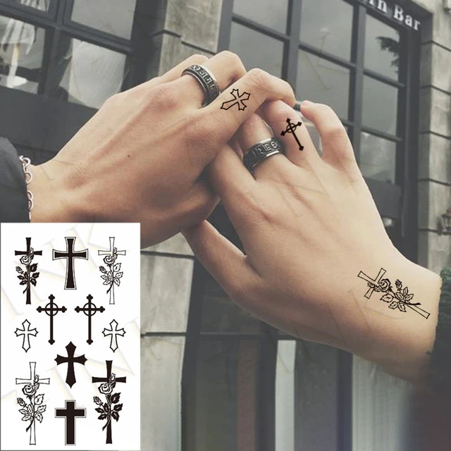 Cross On Ring Finger Tattoo