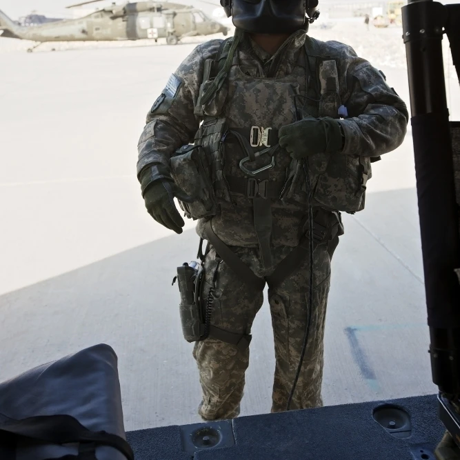 U.S. Army UH 60L Loadmaster confirms pre fliight check on his aircraft ...