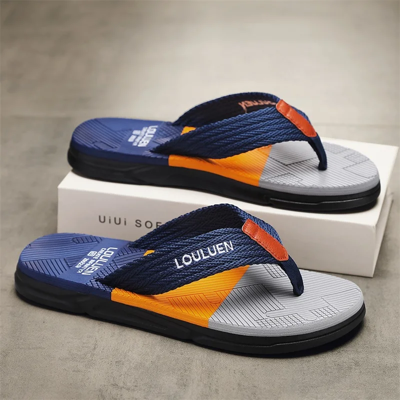 A pair of men's flip - flops with a three - tone spliced sole. The ...