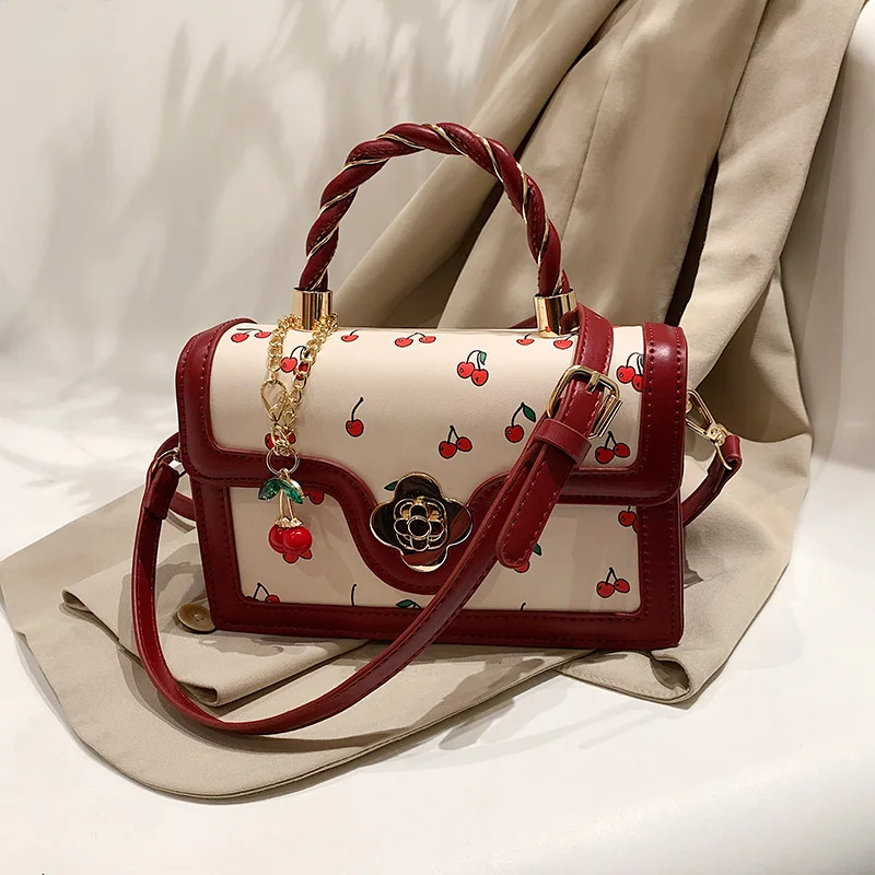 This-Is-a-Red-Handbag-with-a-Cute-Cherry-Design-for-Dating-and-Shopping.jpg