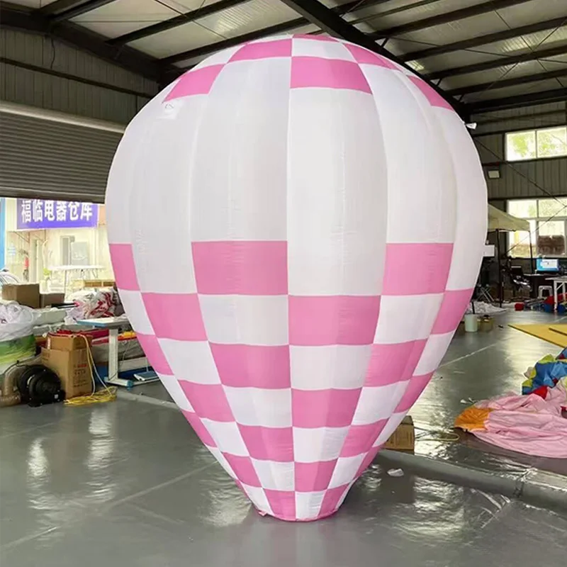 Inflatable hot air balloons with blowers, outdoor grassland scenic area ...