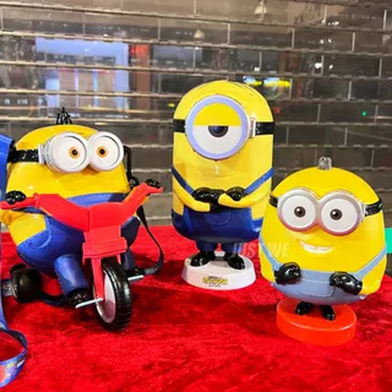 Minions-with-big-eyes-surrounded-by-water-cups-shaped-cups-Otto-riding-bikes-popcorn-buckets ...