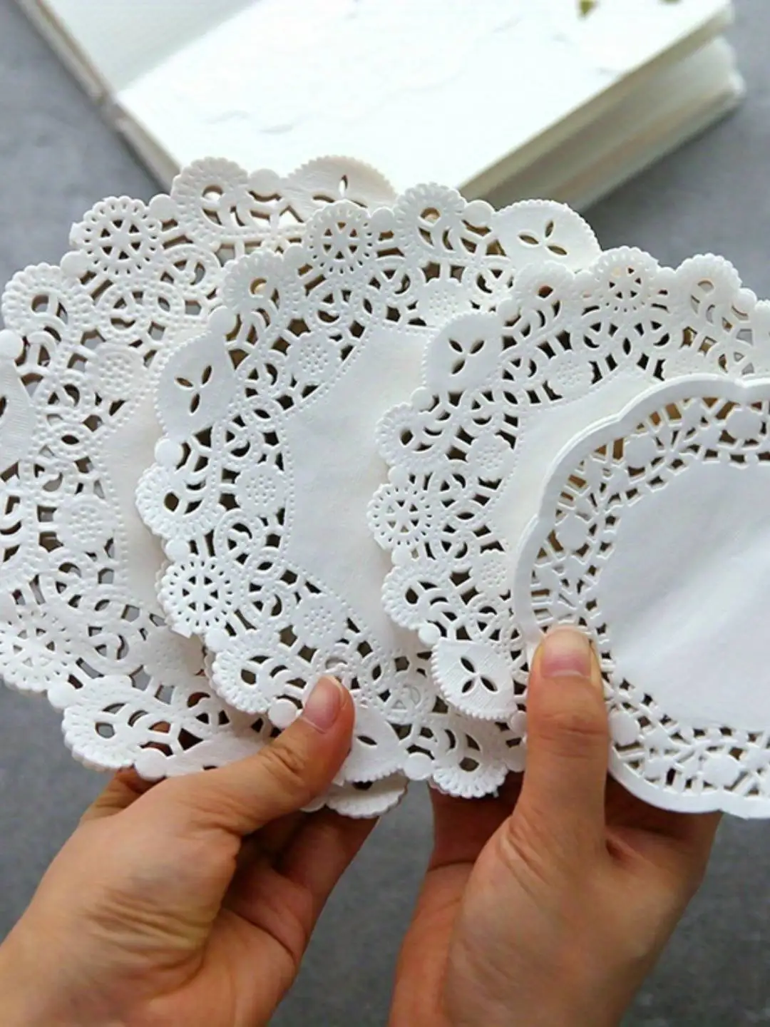 140 white circular lace paper pads with circular cut-out designs ...