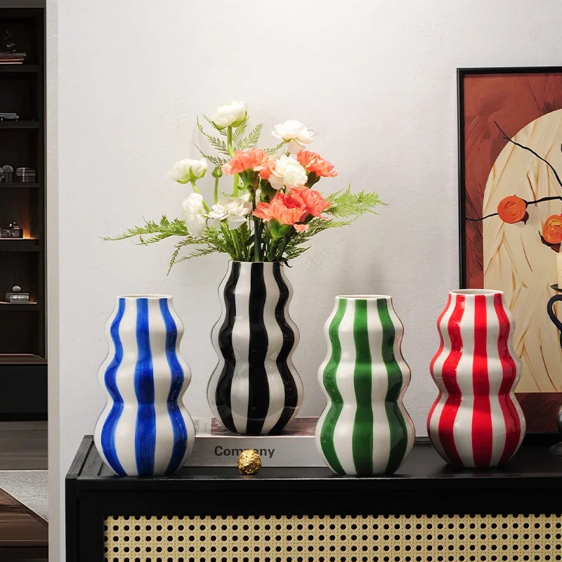 Modern niche minimalist striped vases, flower arrangements in them ...