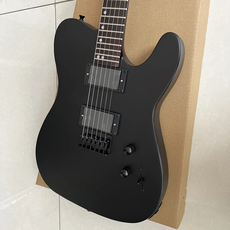This is a classic electric guitar with a black matte body and a unique ...